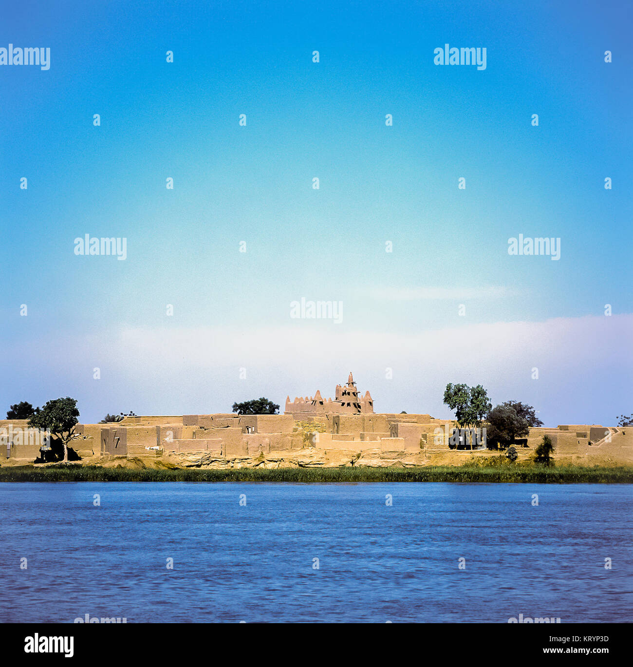View of a village by the Niger river and adobe buildings, Mali Stock ...