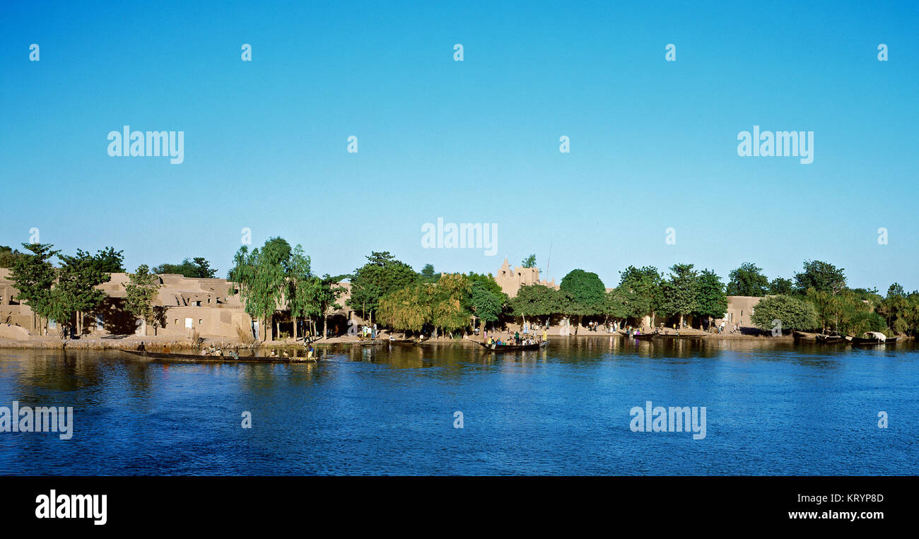 View of a village by the Niger river and adobe buildings, Mali Stock ...