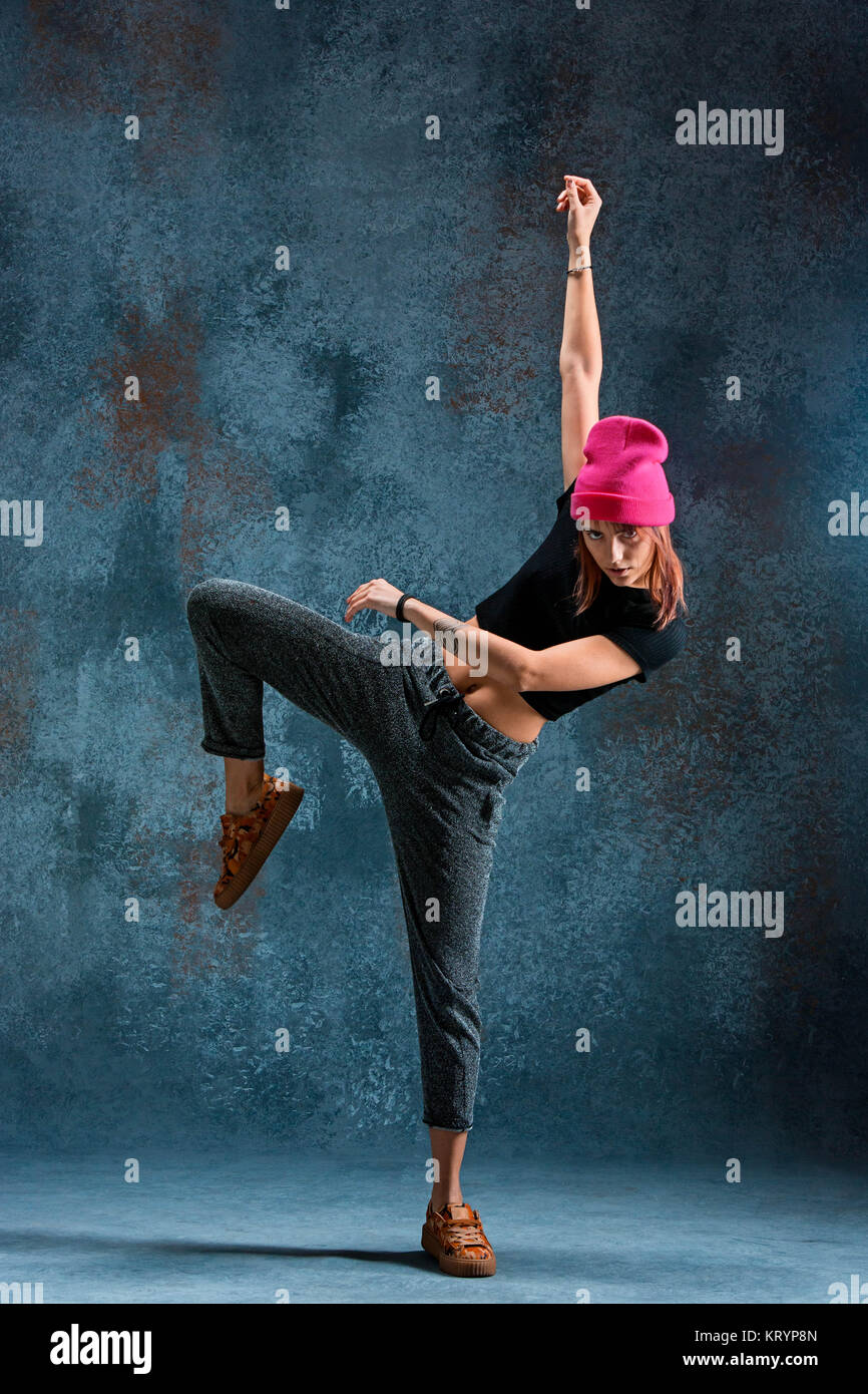 Young girl break dancing on blue studio background Stock Photo - Alamy