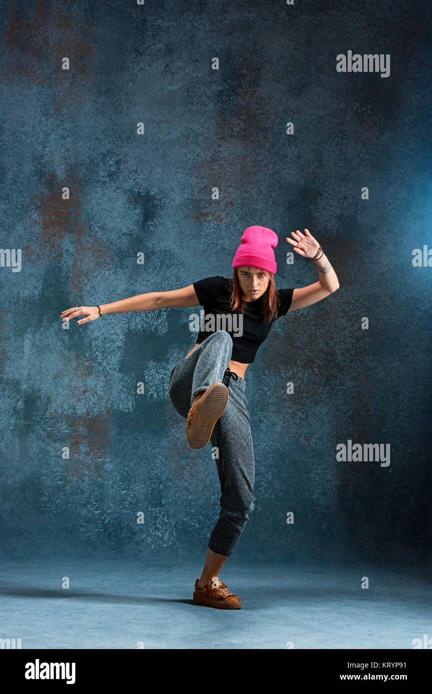 Young girl break dancing on blue studio background Stock Photo - Alamy