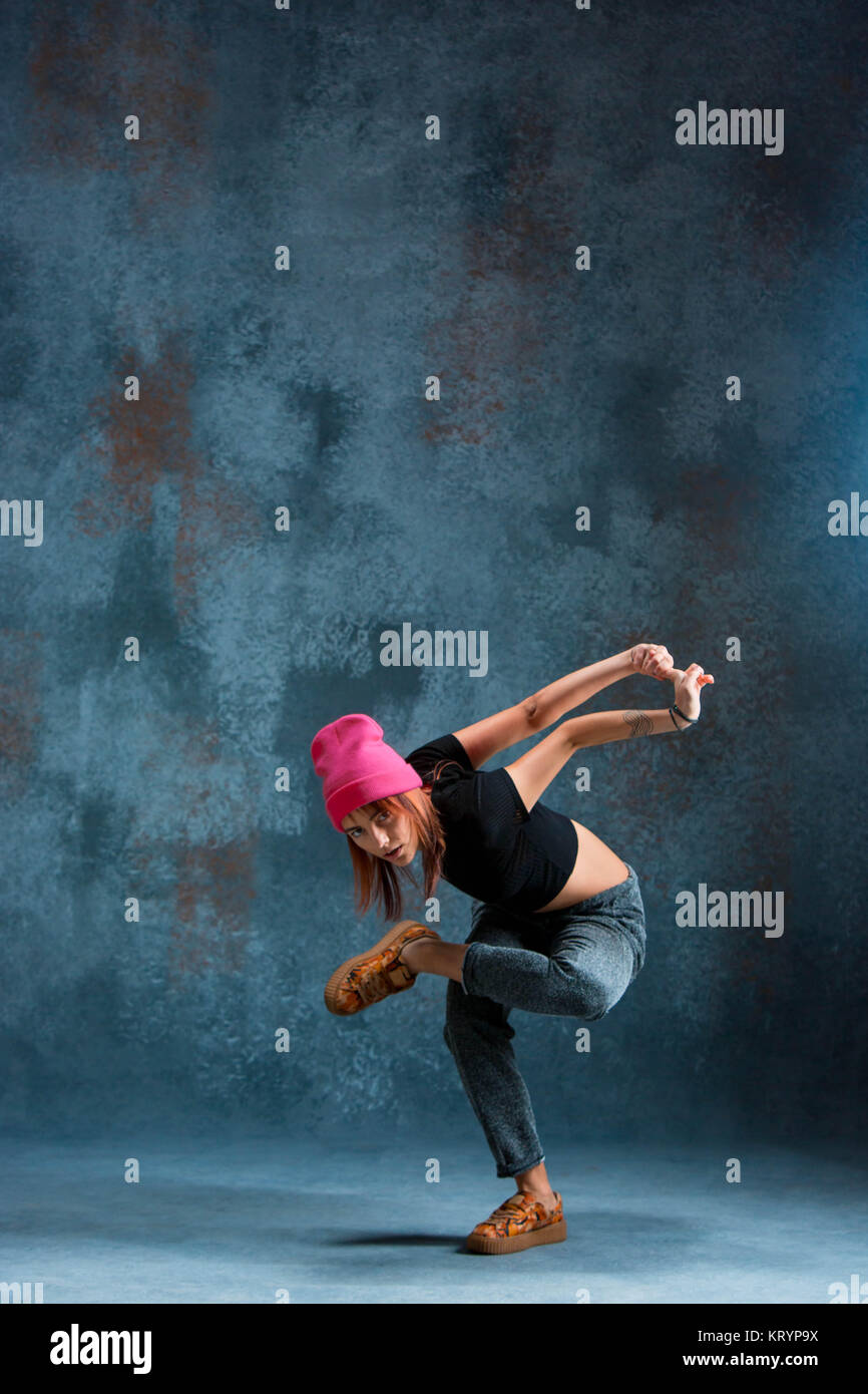Young girl break dancing on blue studio background Stock Photo - Alamy