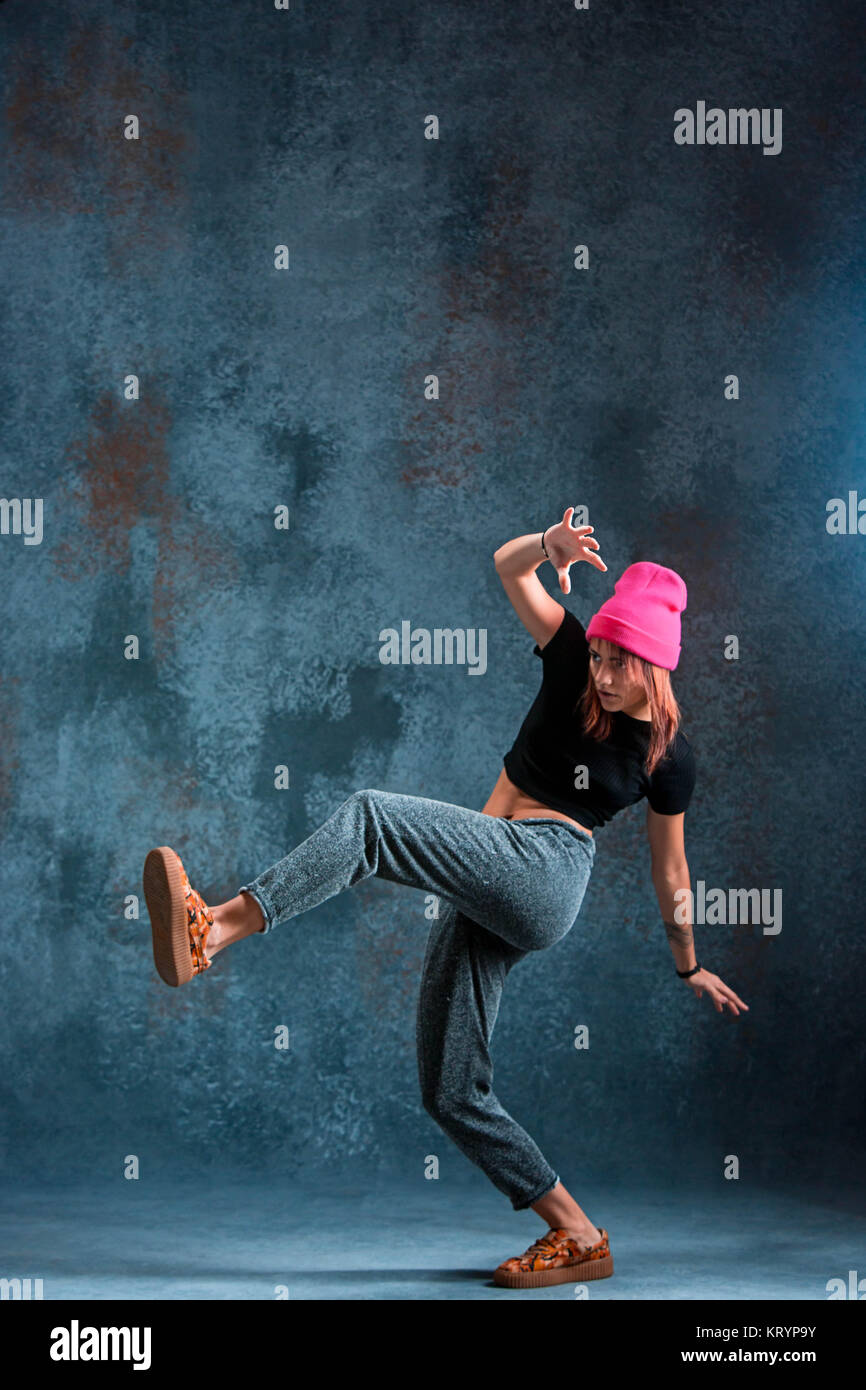Young girl break dancing on blue studio background Stock Photo - Alamy