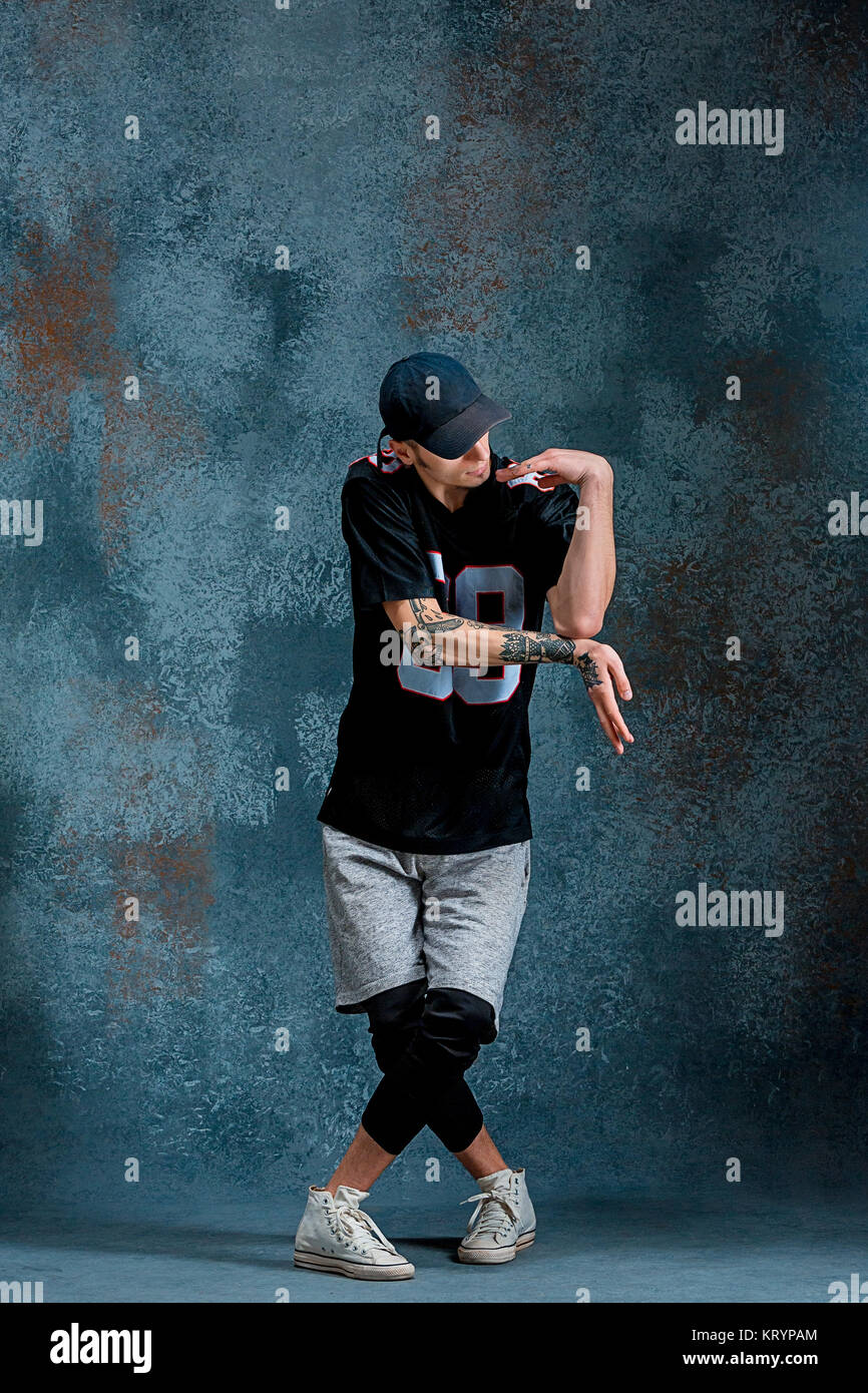Young man break dancing on blue studio background Stock Photo - Alamy