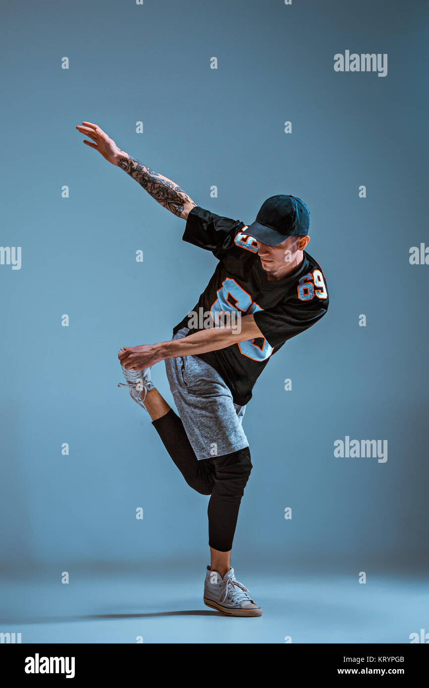 Young man break dancing on wall background Stock Photo - Alamy
