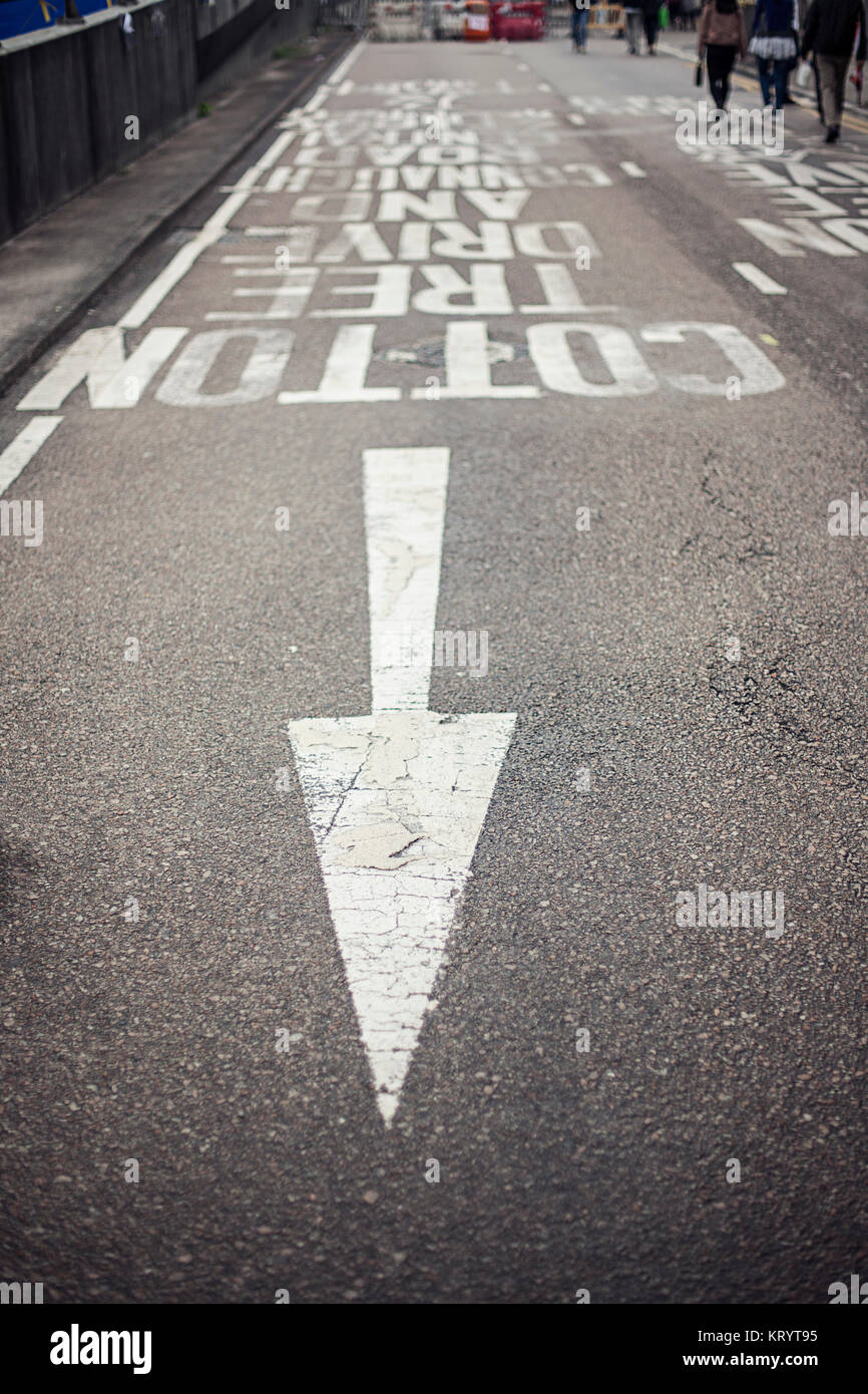 Road markings with arrow on asphalt Stock Photo - Alamy