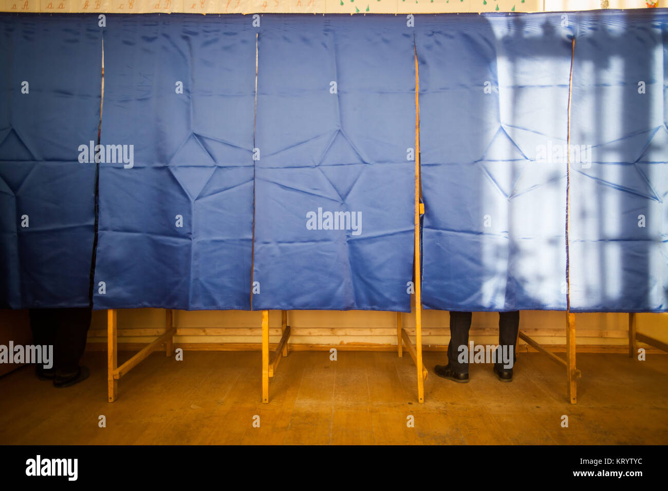 People vote in voting booth Stock Photo - Alamy