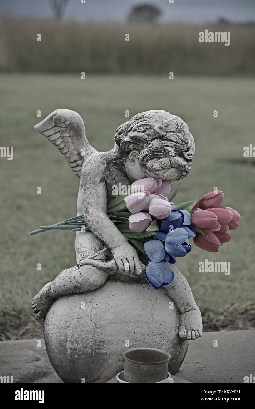 carved stone angel at Delungra cemetary holding flowers and looking sad ...