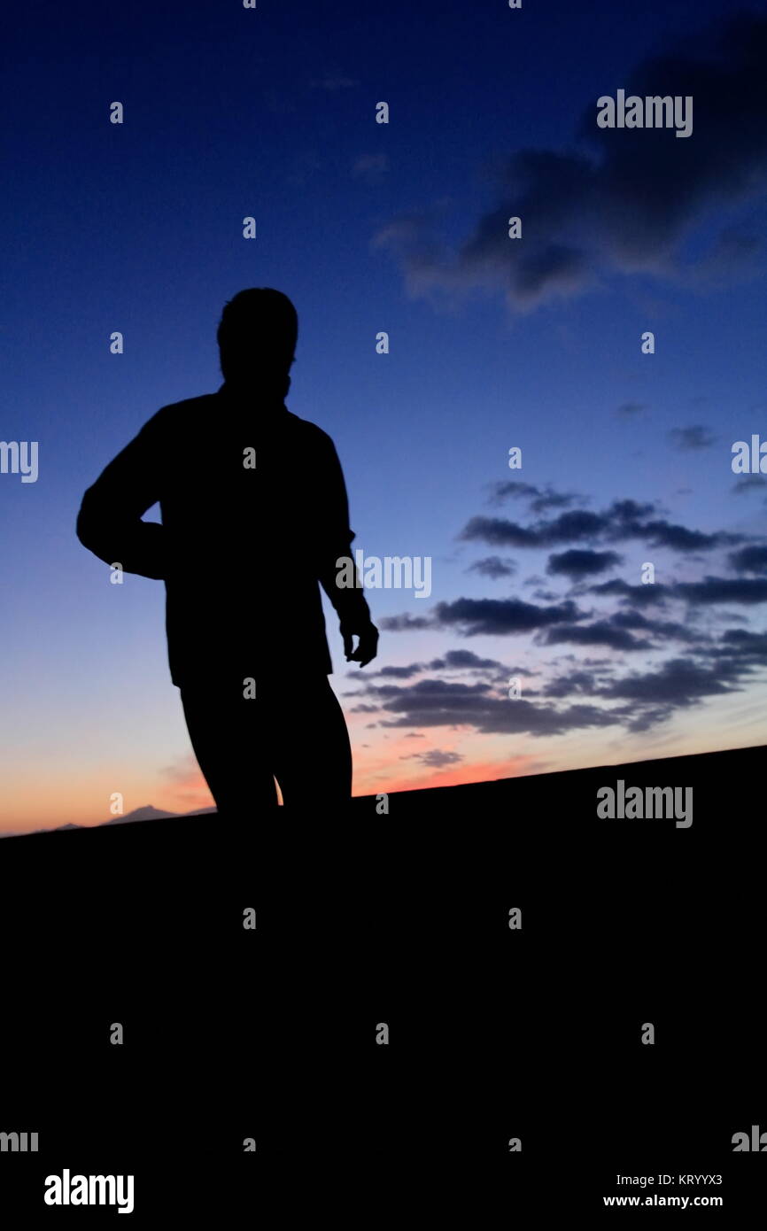 Silhouette of jogger at sunset hi-res stock photography and images - Alamy