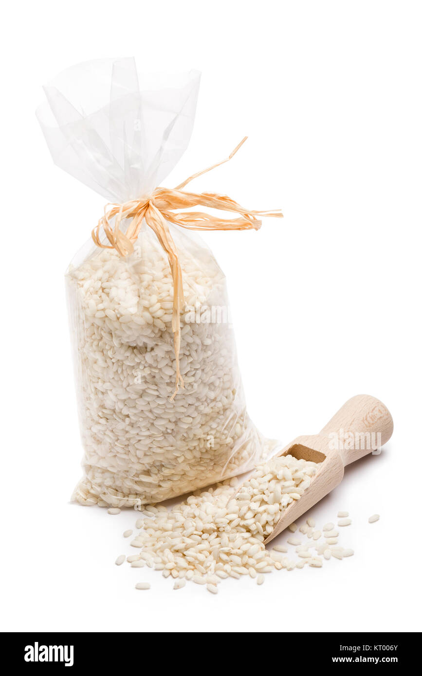 heap of white rice in transparent plastic bag with wooden scoop, on ...