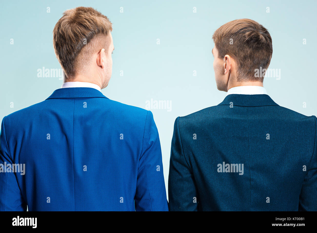 Two young stylish men in a suit. Rear view from the back Stock Photo ...