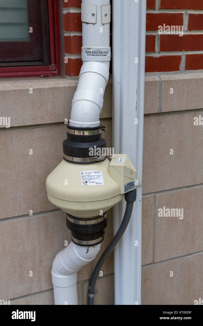 A radon gas reduction system on the outside of a residential building ...