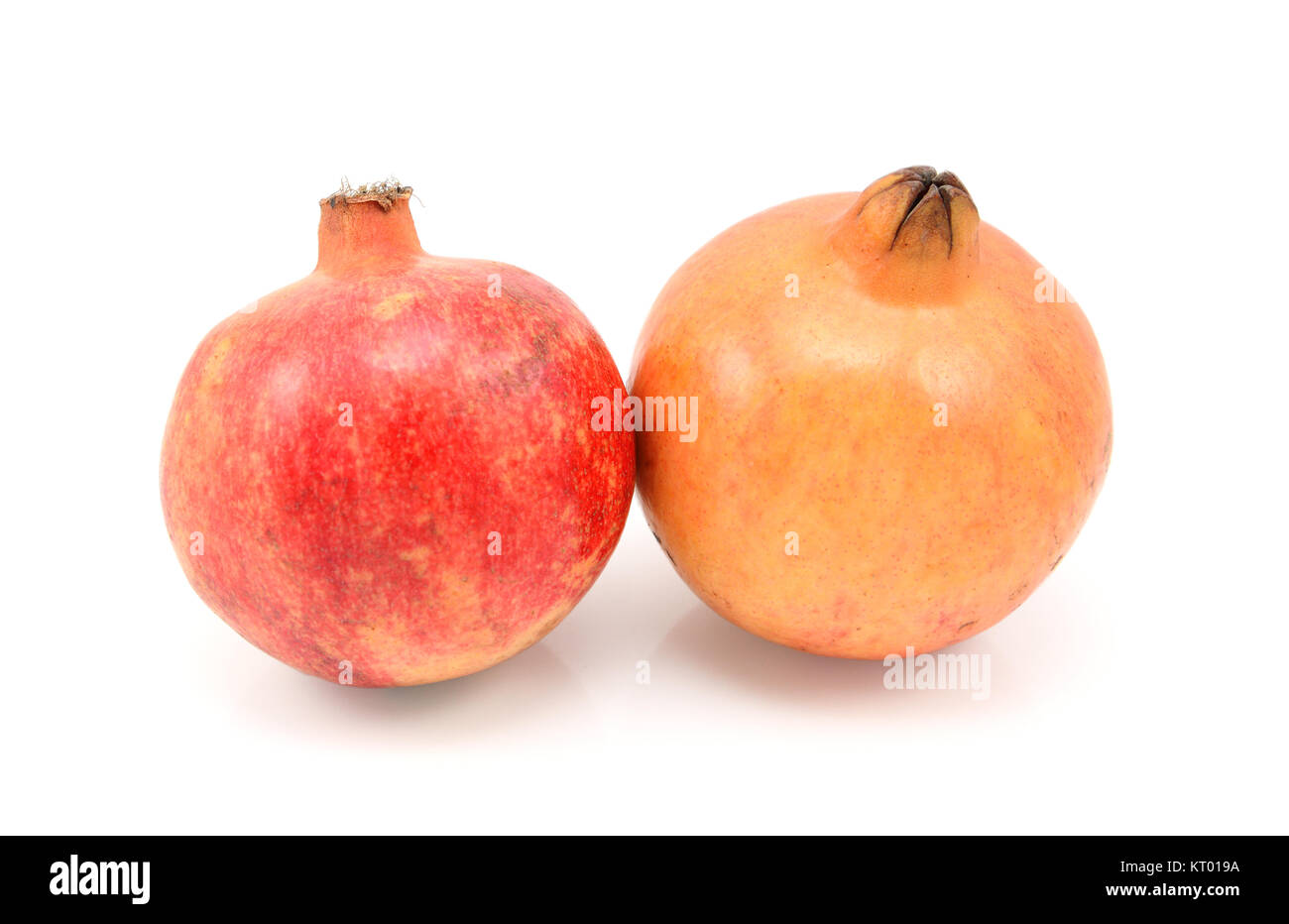 Two pomegranates, red and yellow Stock Photo - Alamy