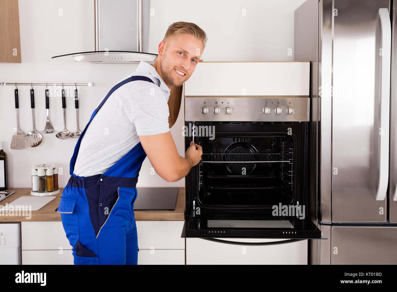 Technician Repairing Oven Stock Photo - Alamy