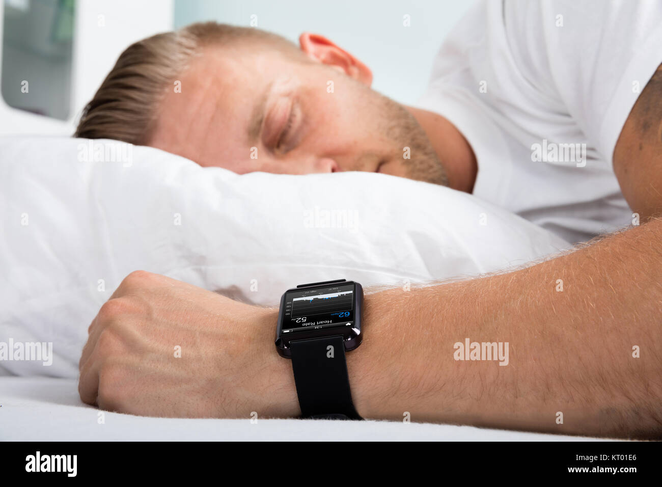 Man Sleeping With Smart Watch In His Hand Stock Photo - Alamy
