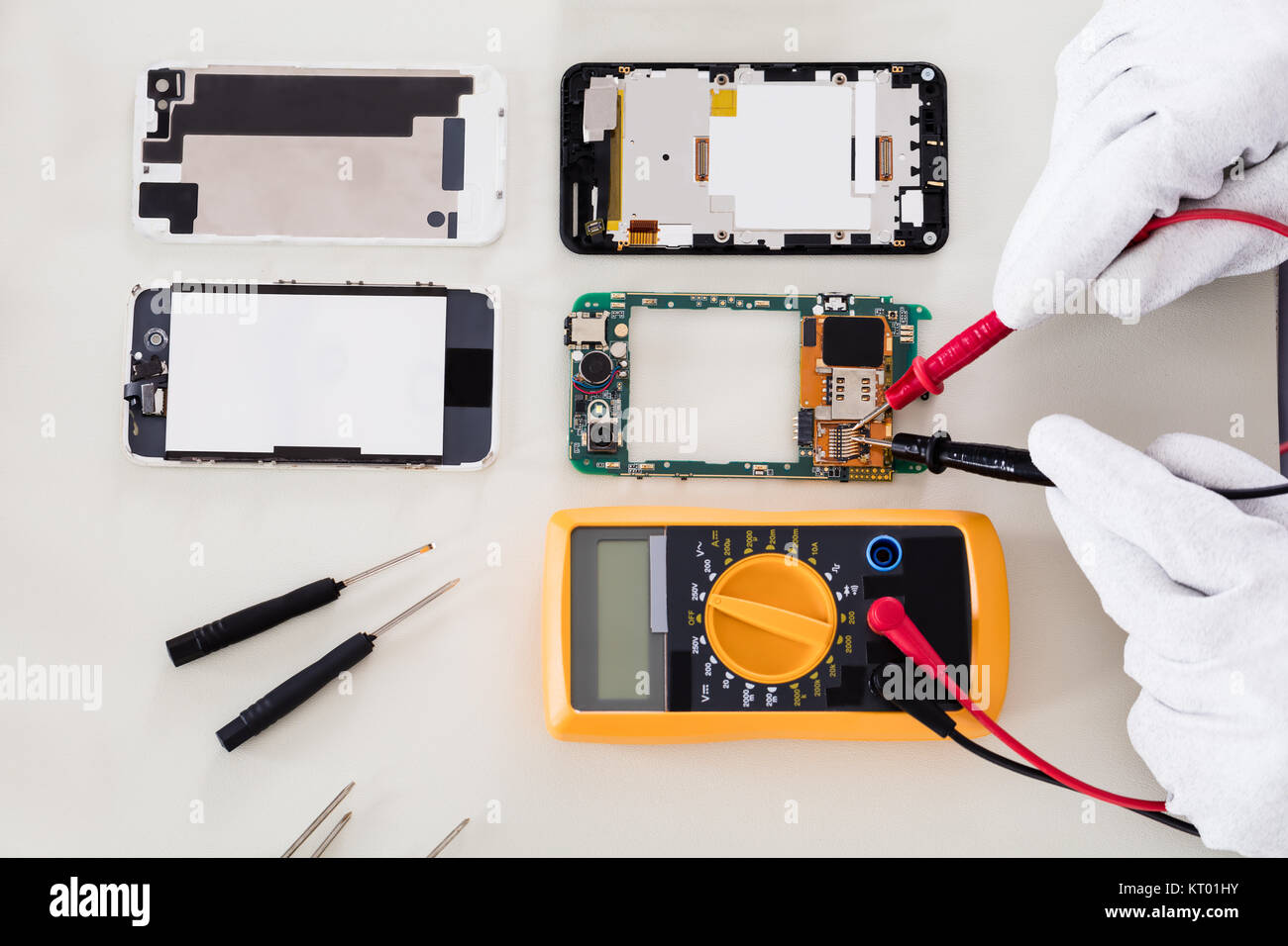 Person Checking Damaged Mobile Phone With Digital Multimeter Stock ...