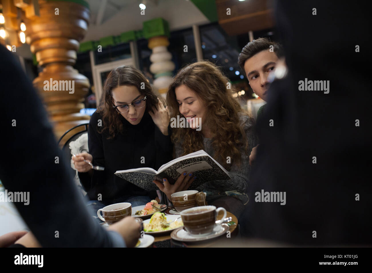 Group of teenagers doing homework in cafe Stock Photo - Alamy