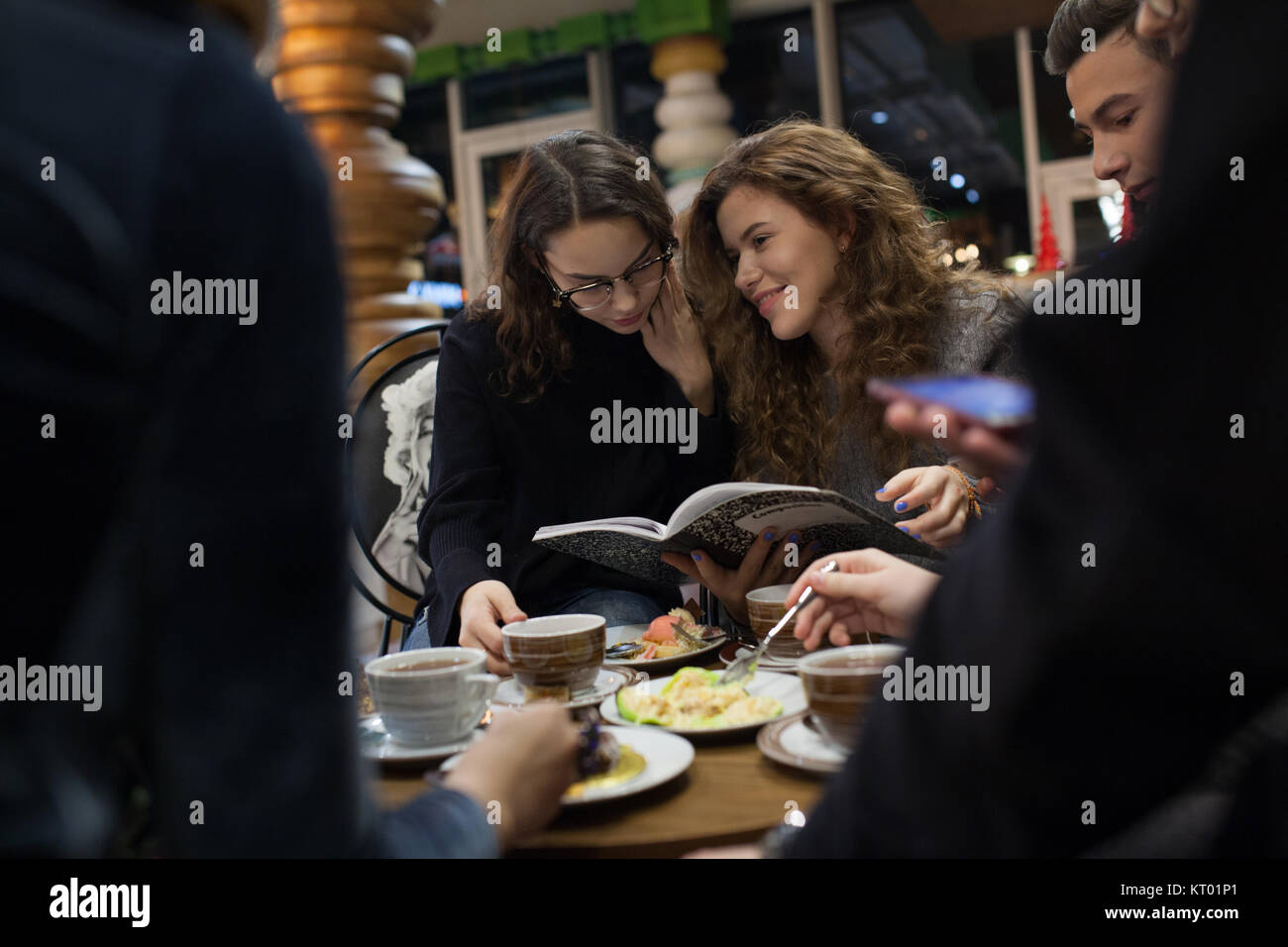 Group of teenagers doing homework in cafe Stock Photo - Alamy
