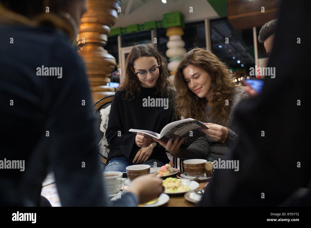 Group of teenagers doing homework in cafe Stock Photo - Alamy