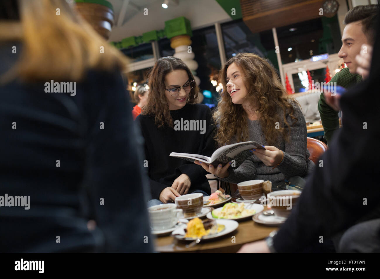 Group of teenagers doing homework in cafe Stock Photo - Alamy