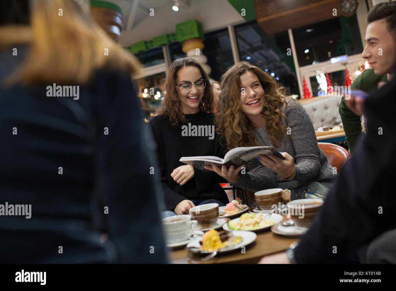 Group of teenagers doing homework in cafe Stock Photo - Alamy