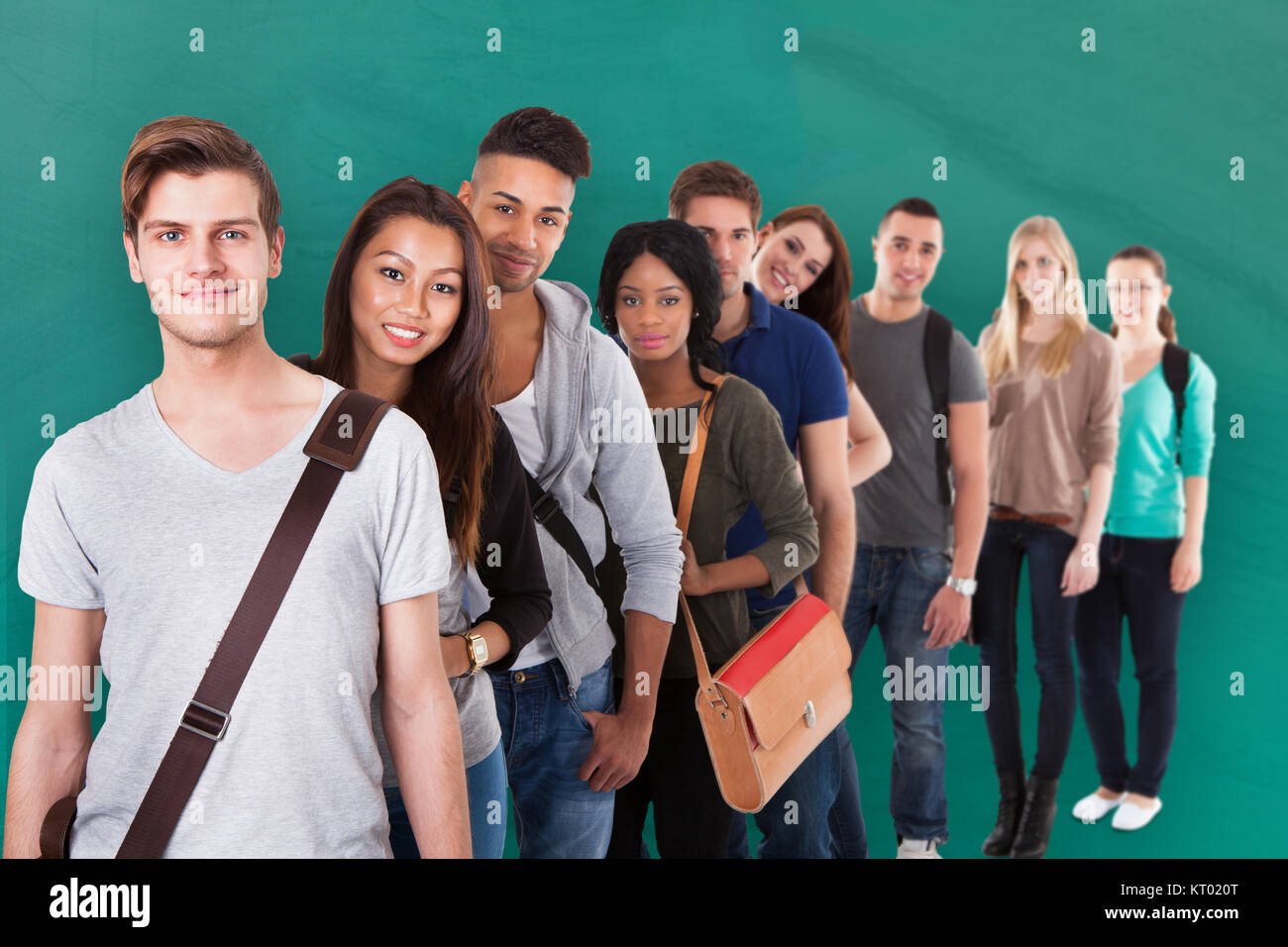 Confident College Students Standing In A Queue Stock Photo - Alamy