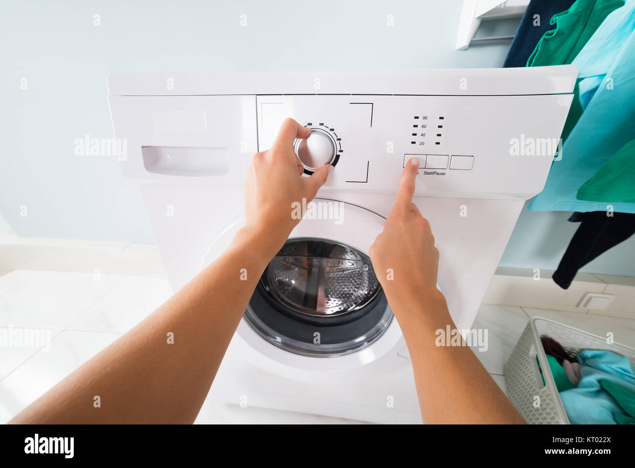 Person Pressing Button Of Washing Machine Stock Photo - Alamy
