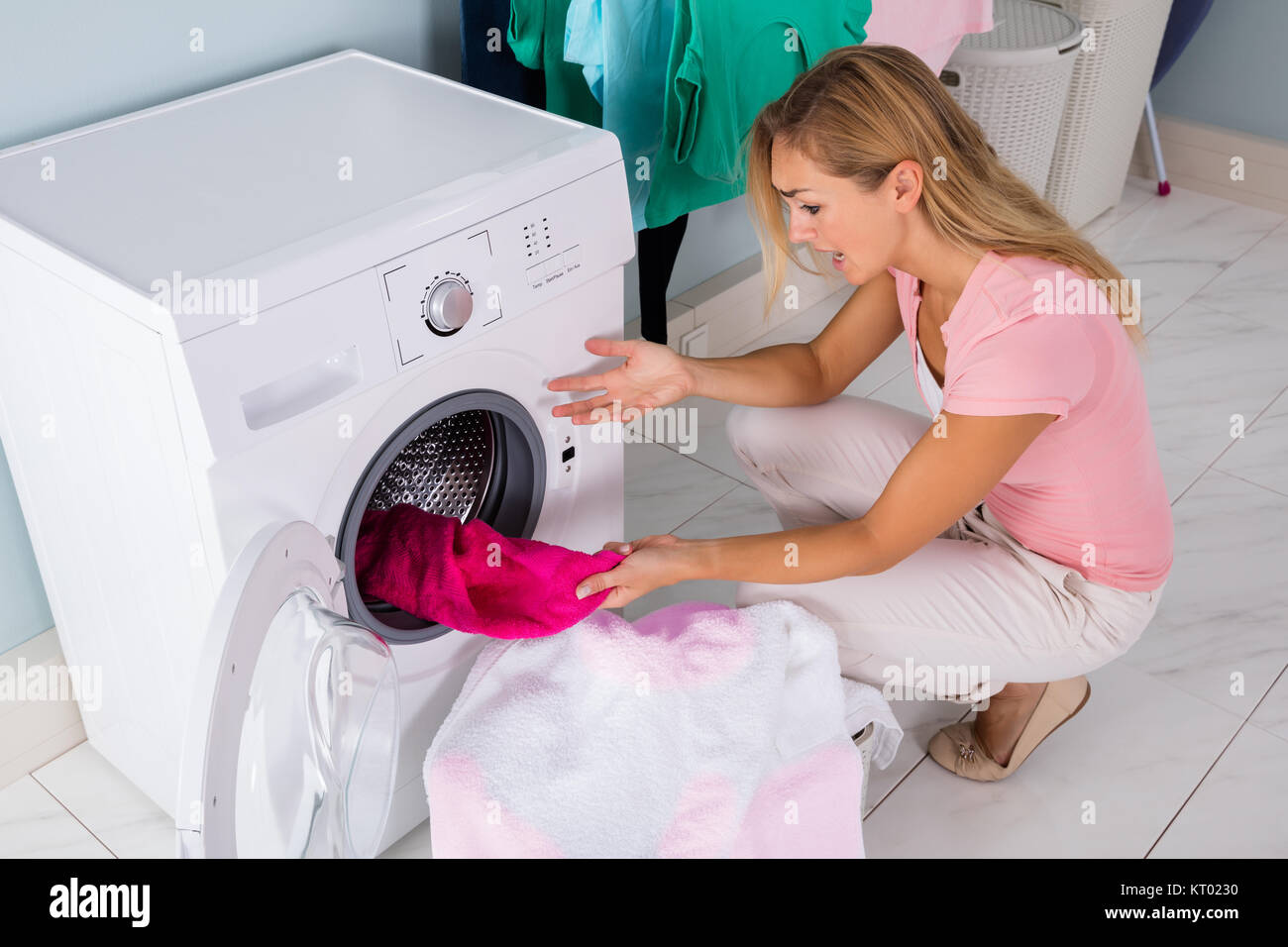 Woman Looking At Stained Cloth In Washing Machine Stock Photo - Alamy