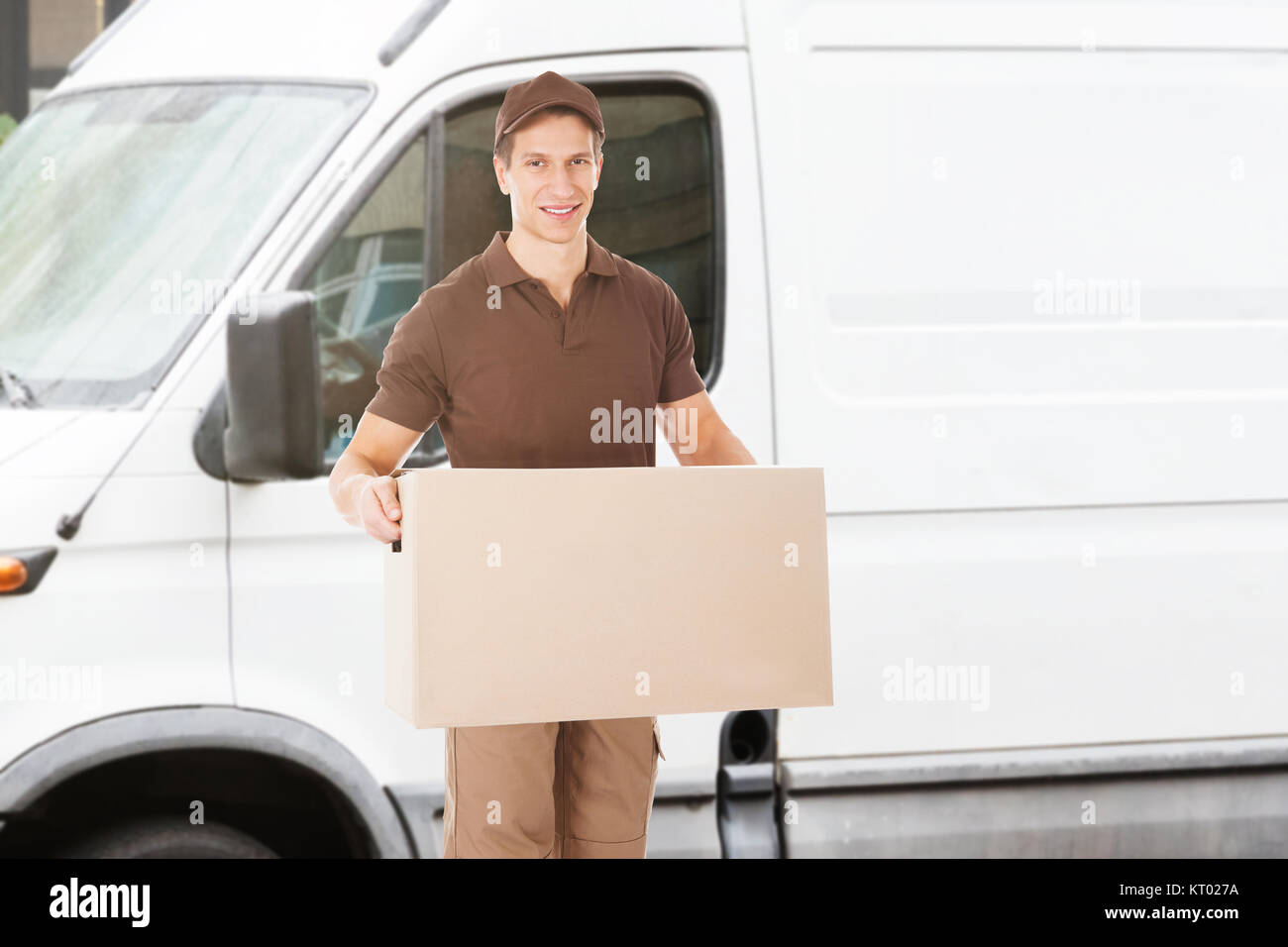 Delivery Man Carrying Box Stock Photo - Alamy