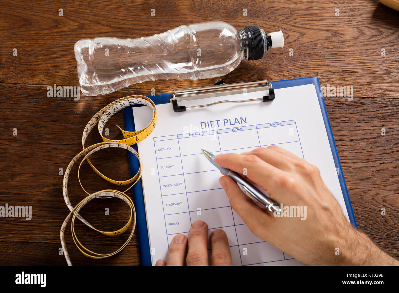 Person Filling Diet Plan Form At Desk Stock Photo - Alamy