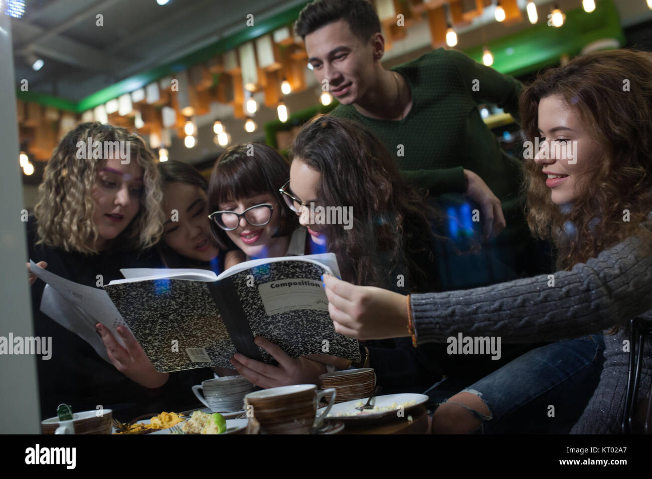 Group of teenagers doing homework in cafe Stock Photo - Alamy