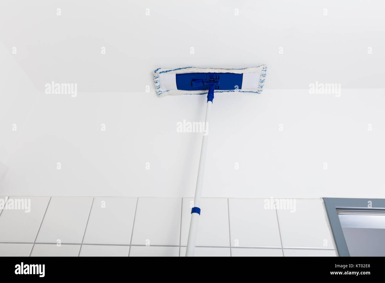 Mop Wiping On The Ceiling Of The Bathroom Stock Photo - Alamy