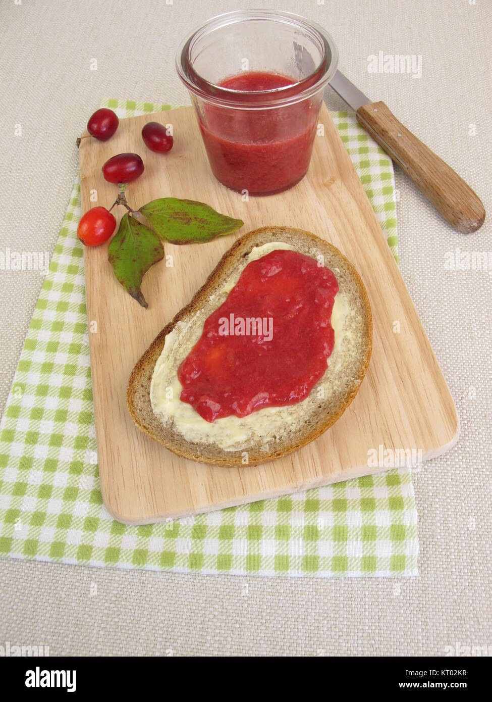 Butterbread with cornel cherry jam for breakfast Stock Photo - Alamy