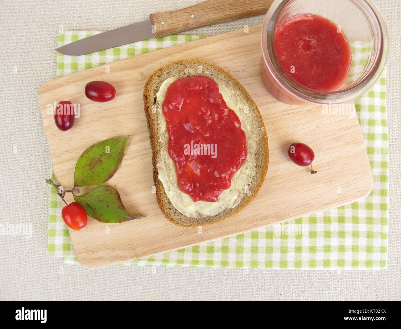 Butterbread with cornel cherry jam for breakfast Stock Photo - Alamy