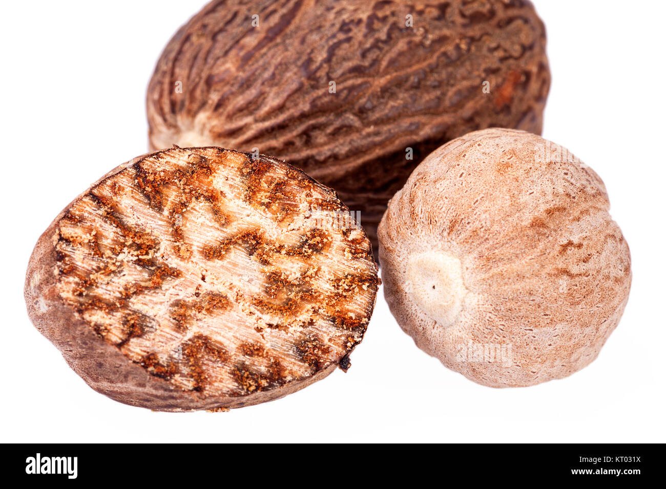Nutmeg , half and cut isolated on white background, close up Stock ...