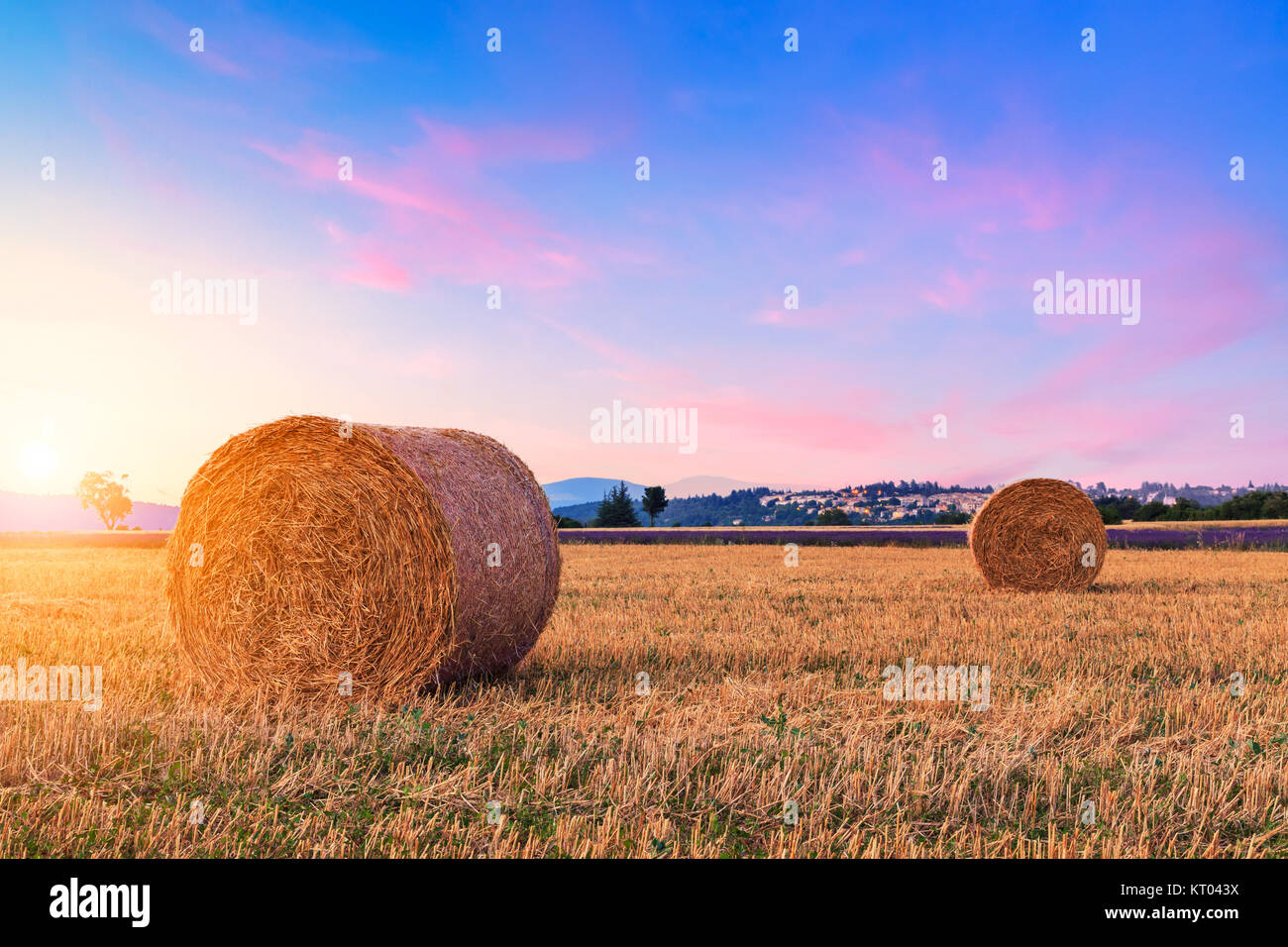Sunset over farm field with hay bales near Sault Stock Photo - Alamy