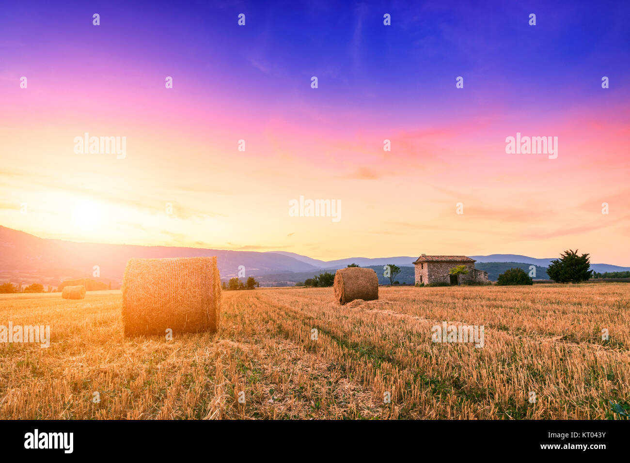 Sunset over farm field with hay bales near Sault Stock Photo - Alamy