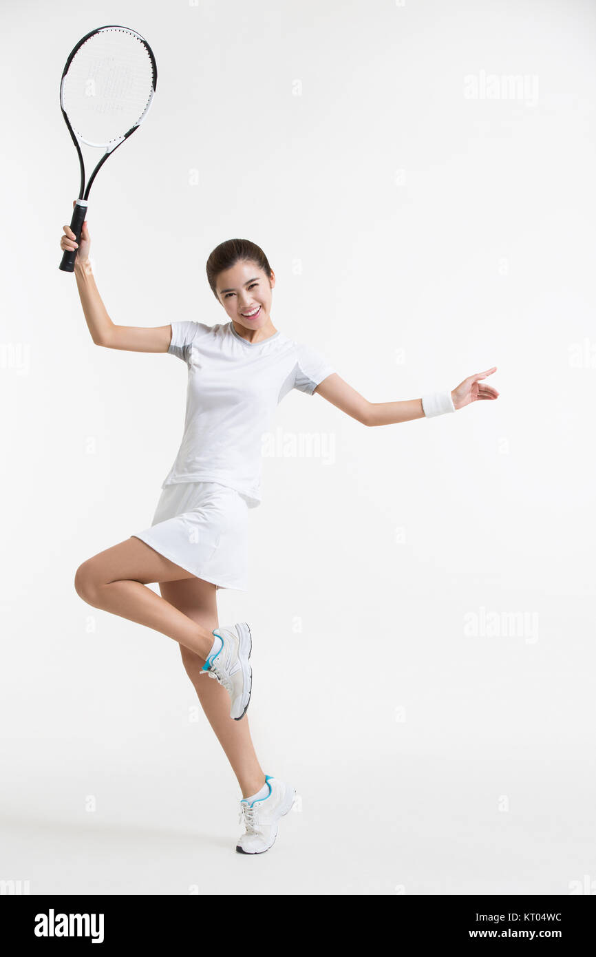 Young woman posing with tennis racket Stock Photo - Alamy