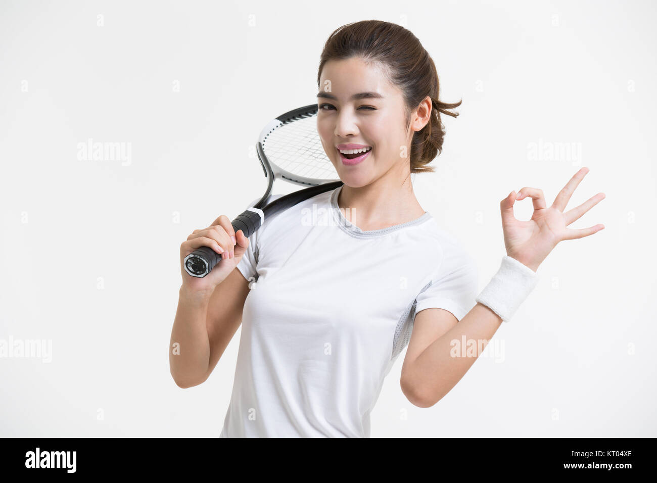Young woman posing with tennis racket Stock Photo - Alamy