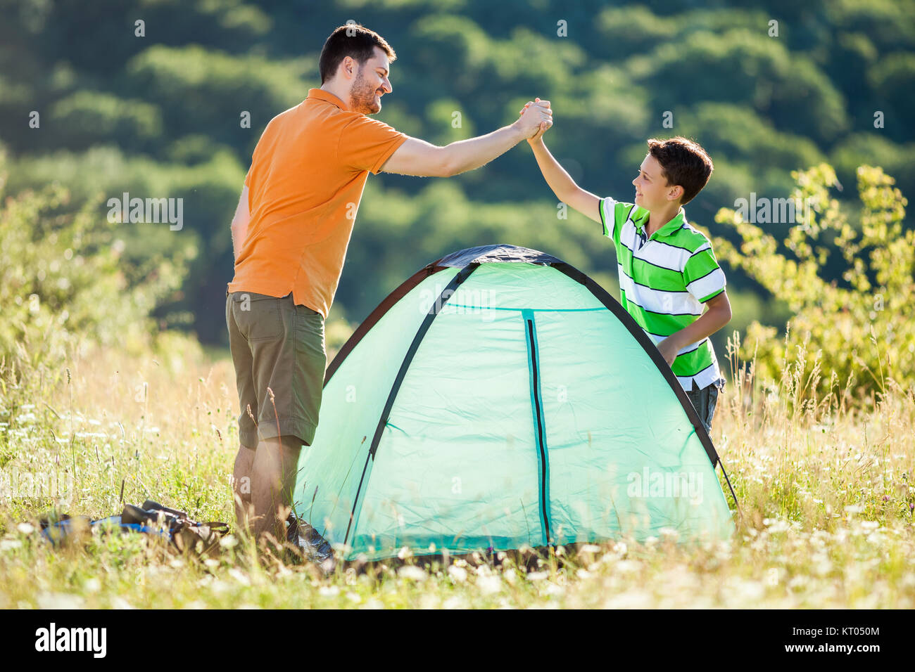Father and son are setting up their tent in nature Stock Photo - Alamy