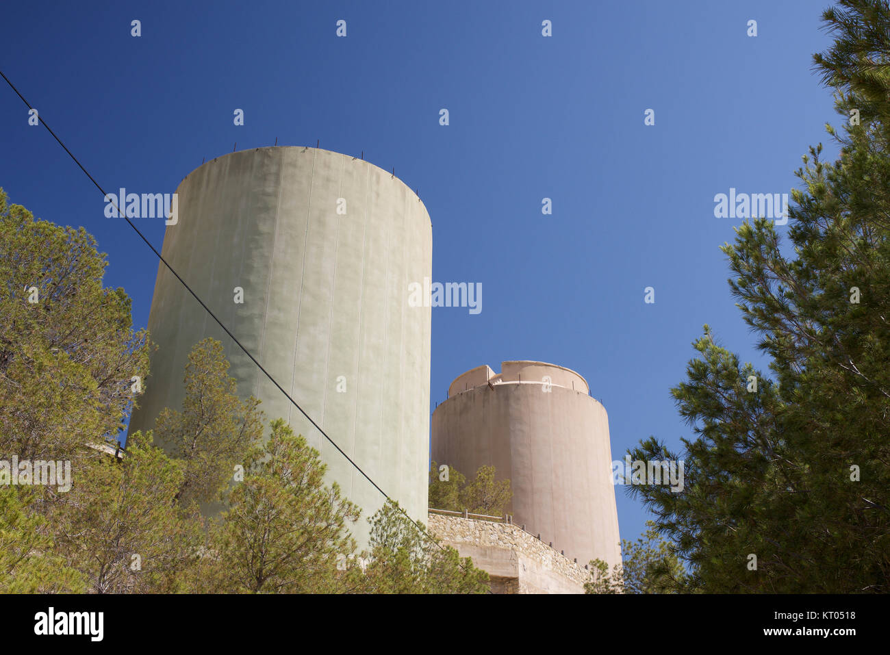 Two circular concrete towers against a blue sky Stock Photo - Alamy