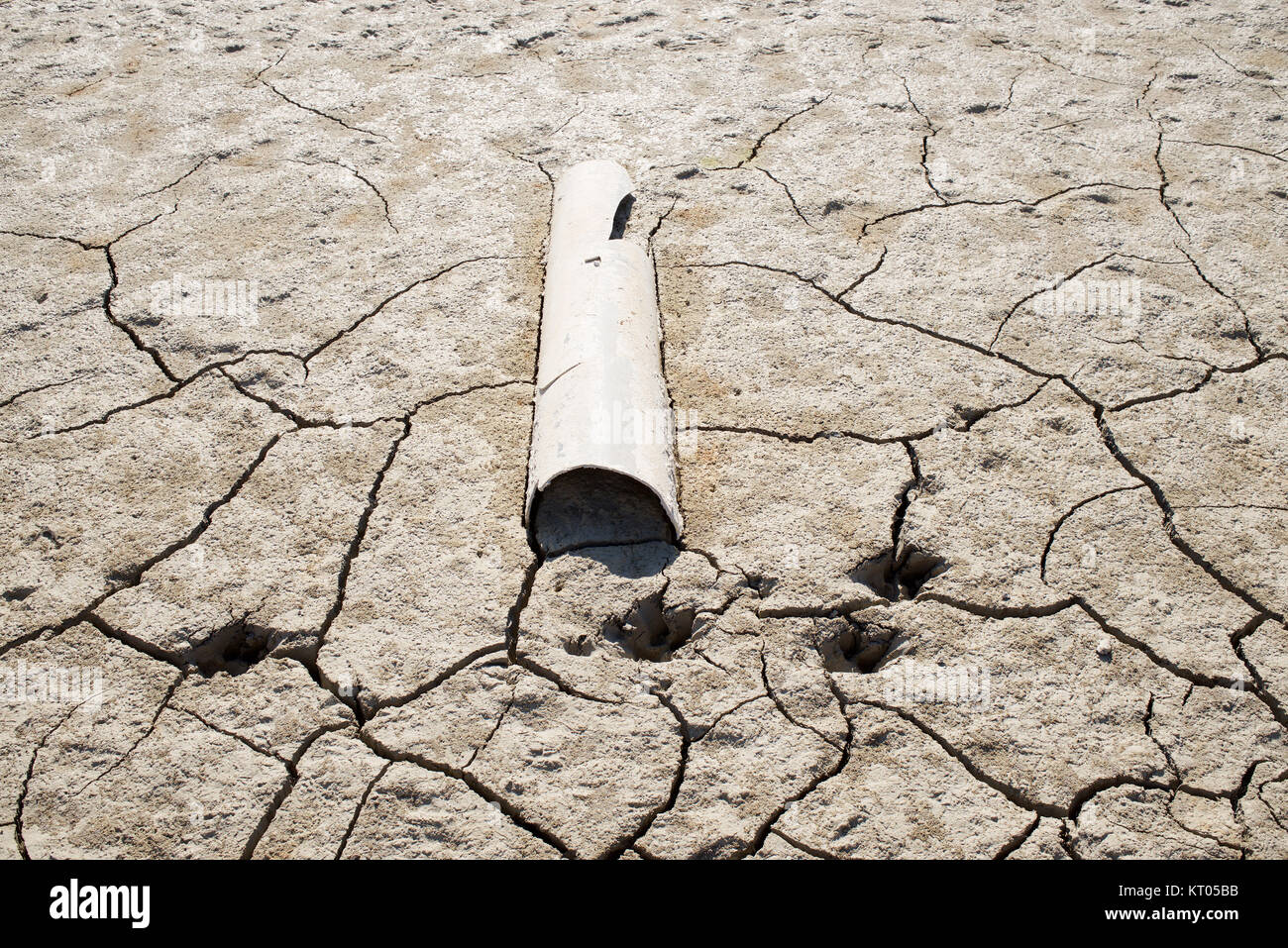 Cracked earth and object on the bed of a reservoir Stock Photo - Alamy