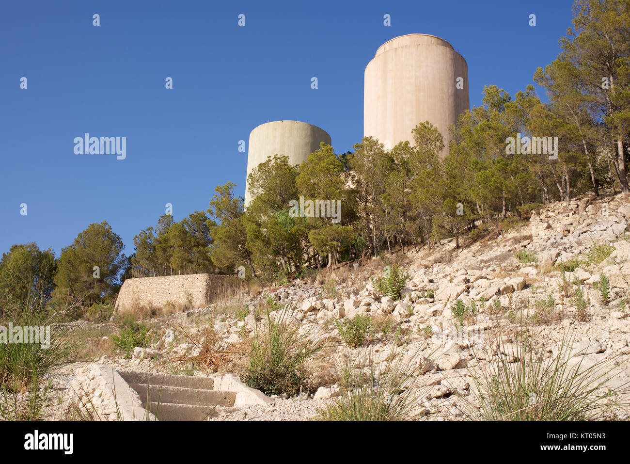 Two circular concrete towers against a blue sky Stock Photo - Alamy