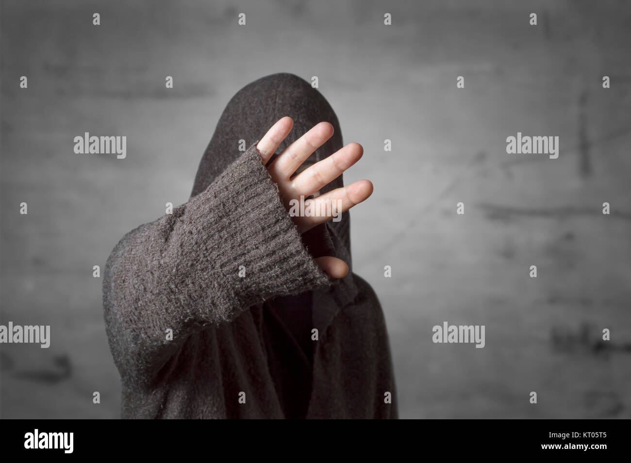 Celebrity is hiding face with a hand from paparazzi photographers. Stop ...
