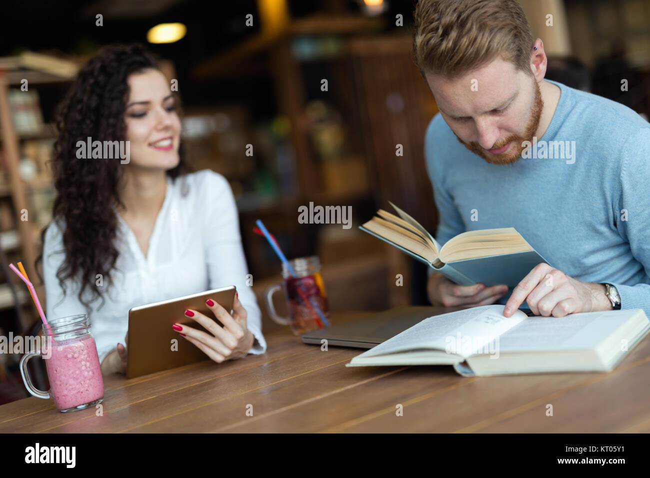 Two school students reading together hi-res stock photography and ...