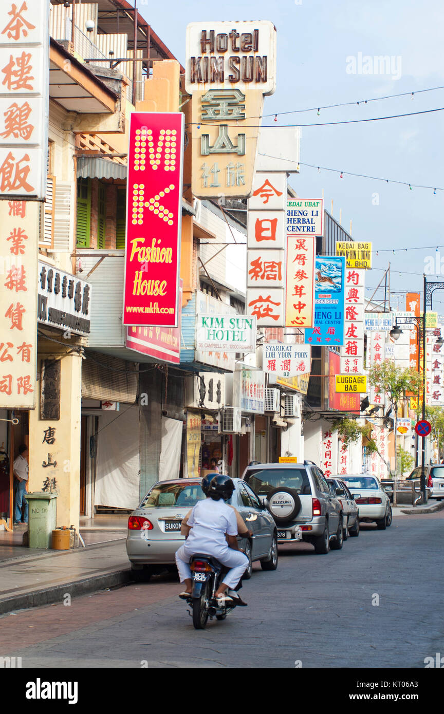Georgetown, Malaysia - December, 6 2004: Motorcycle drives down a ...