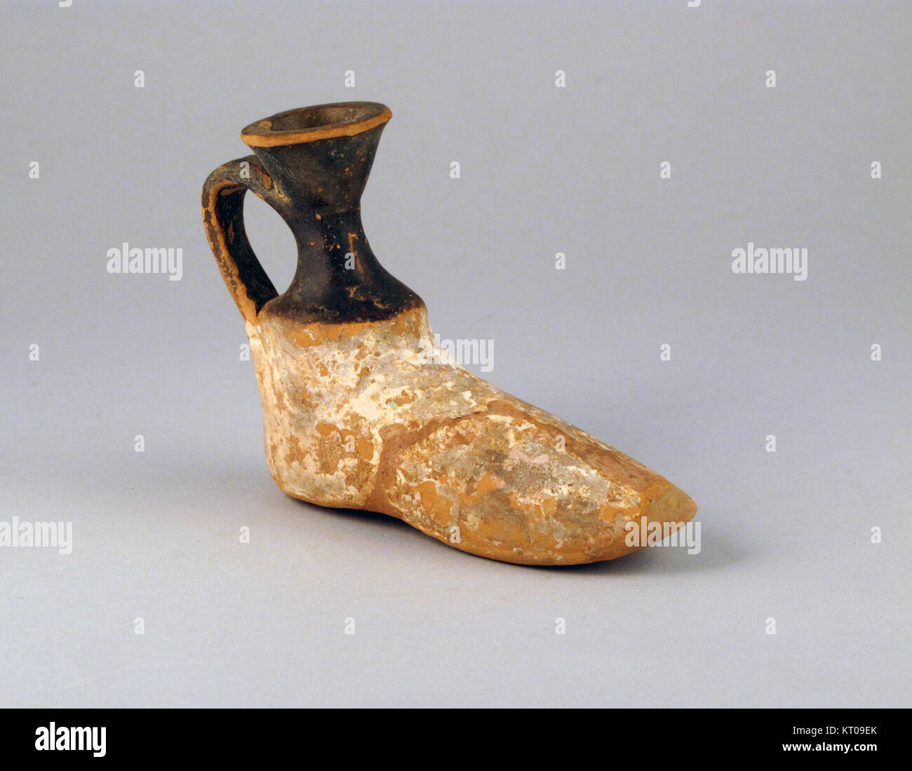 This ancient Greek aryballos, in the shape of a foot with a shoe, is a ...