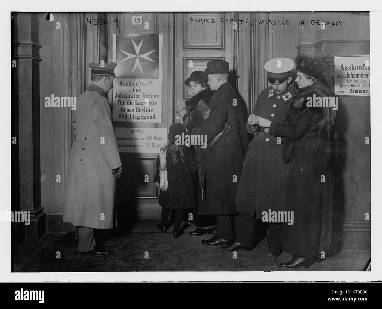This photograph, likely taken post-WWII, depicts individuals involved in efforts to locate ...