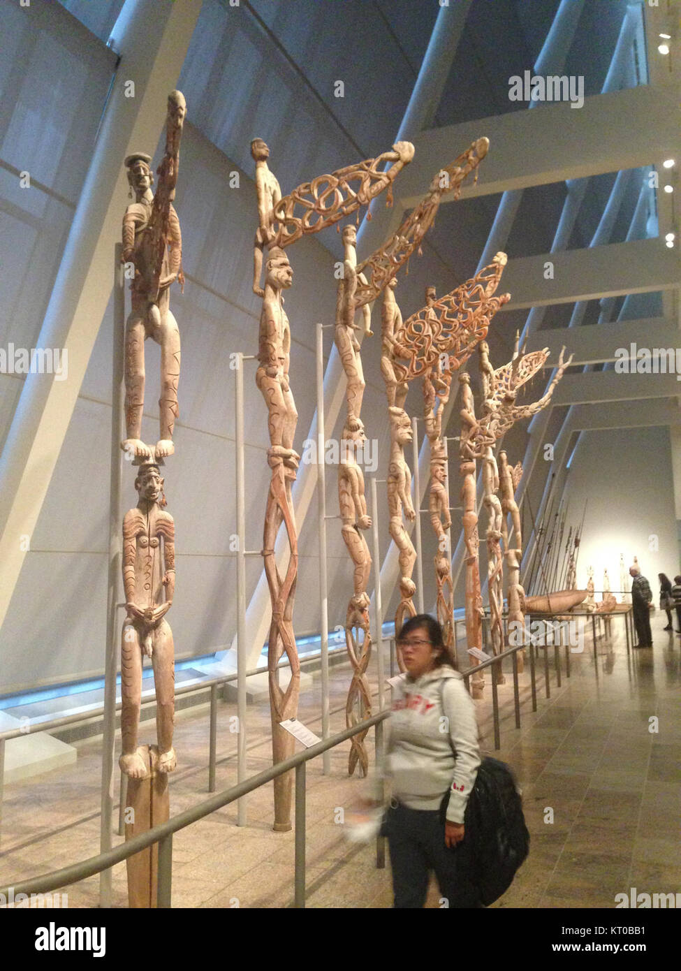 This image displays traditional Asmat wooden poles, an important aspect ...