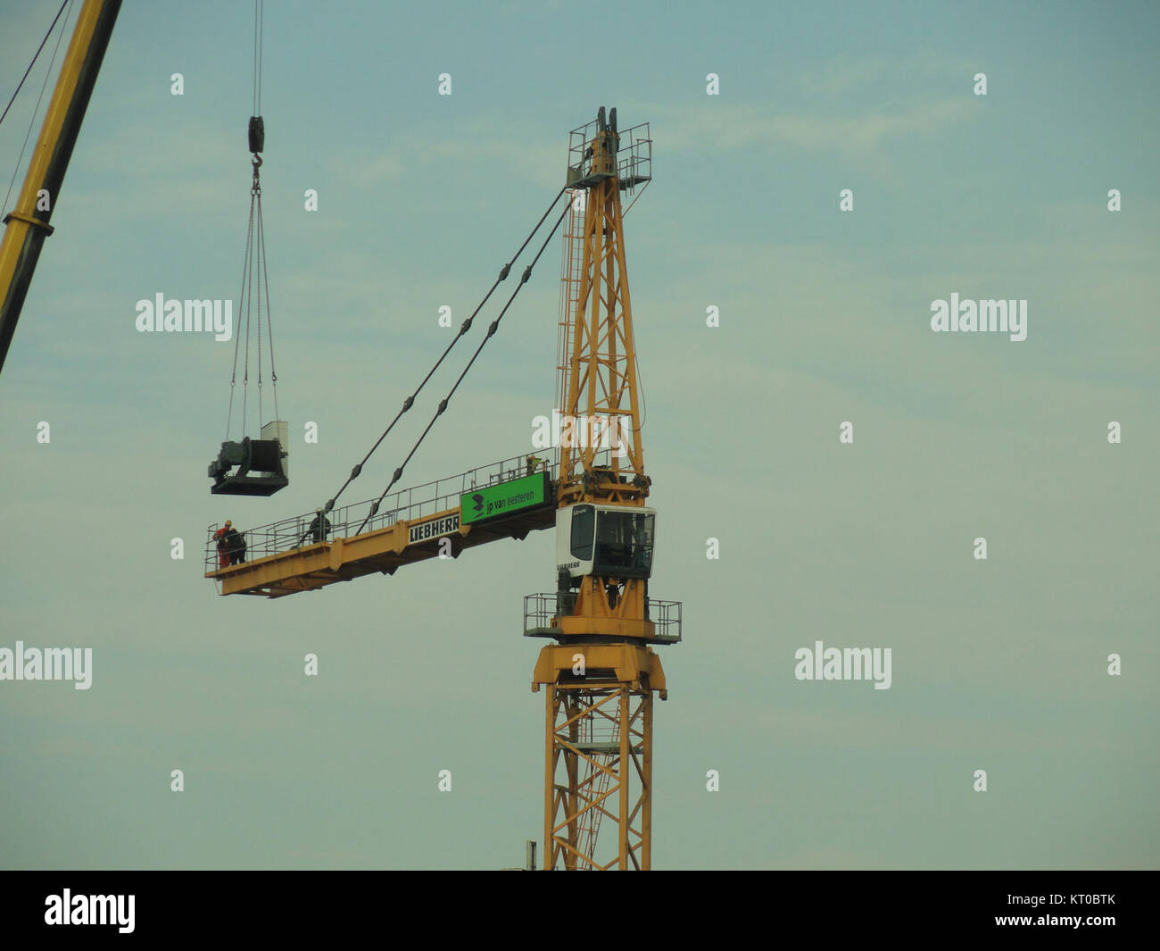 Photograph showing the assembly process of a Liebherr tower crane ...