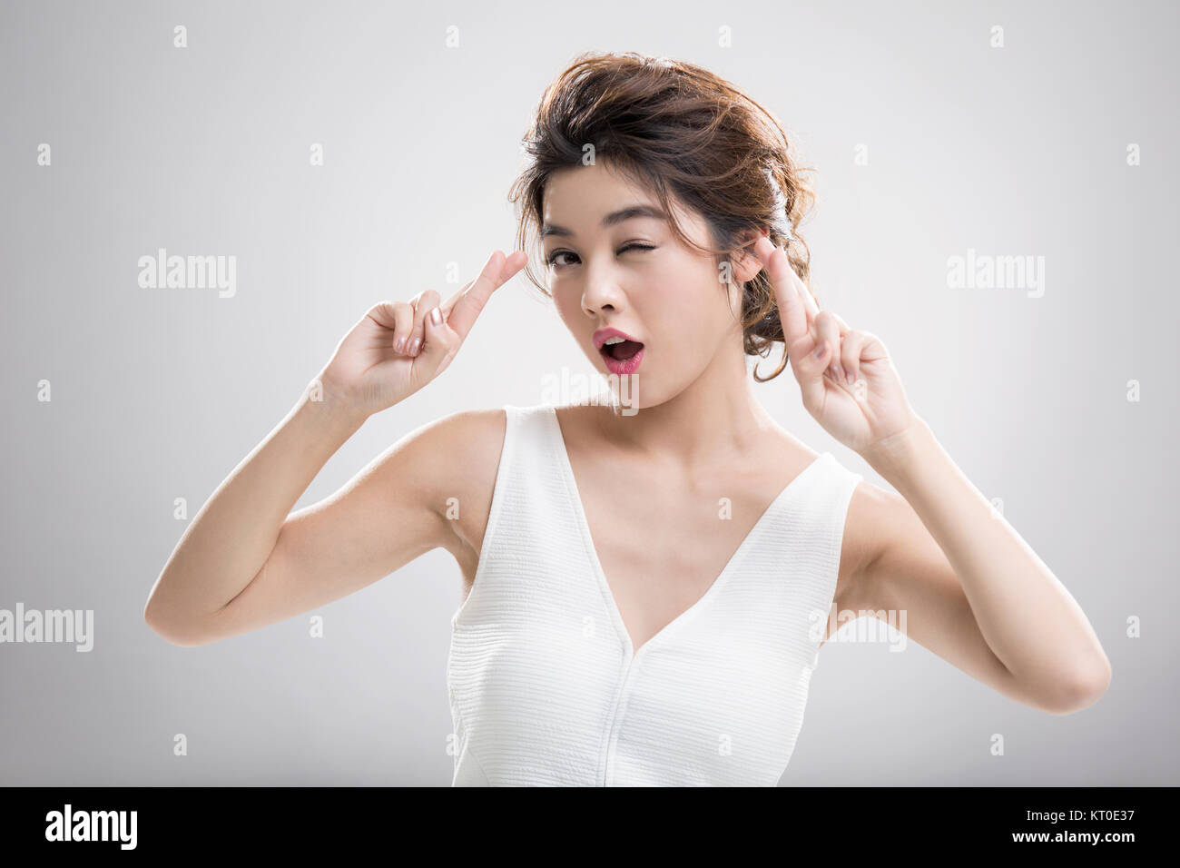 Beautiful young woman fingers crossed hi-res stock photography and ...